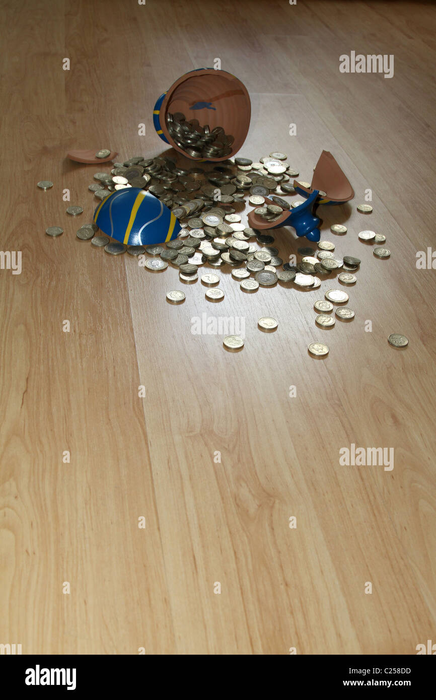 Broken money box spilling out pound coins Stock Photo - Alamy