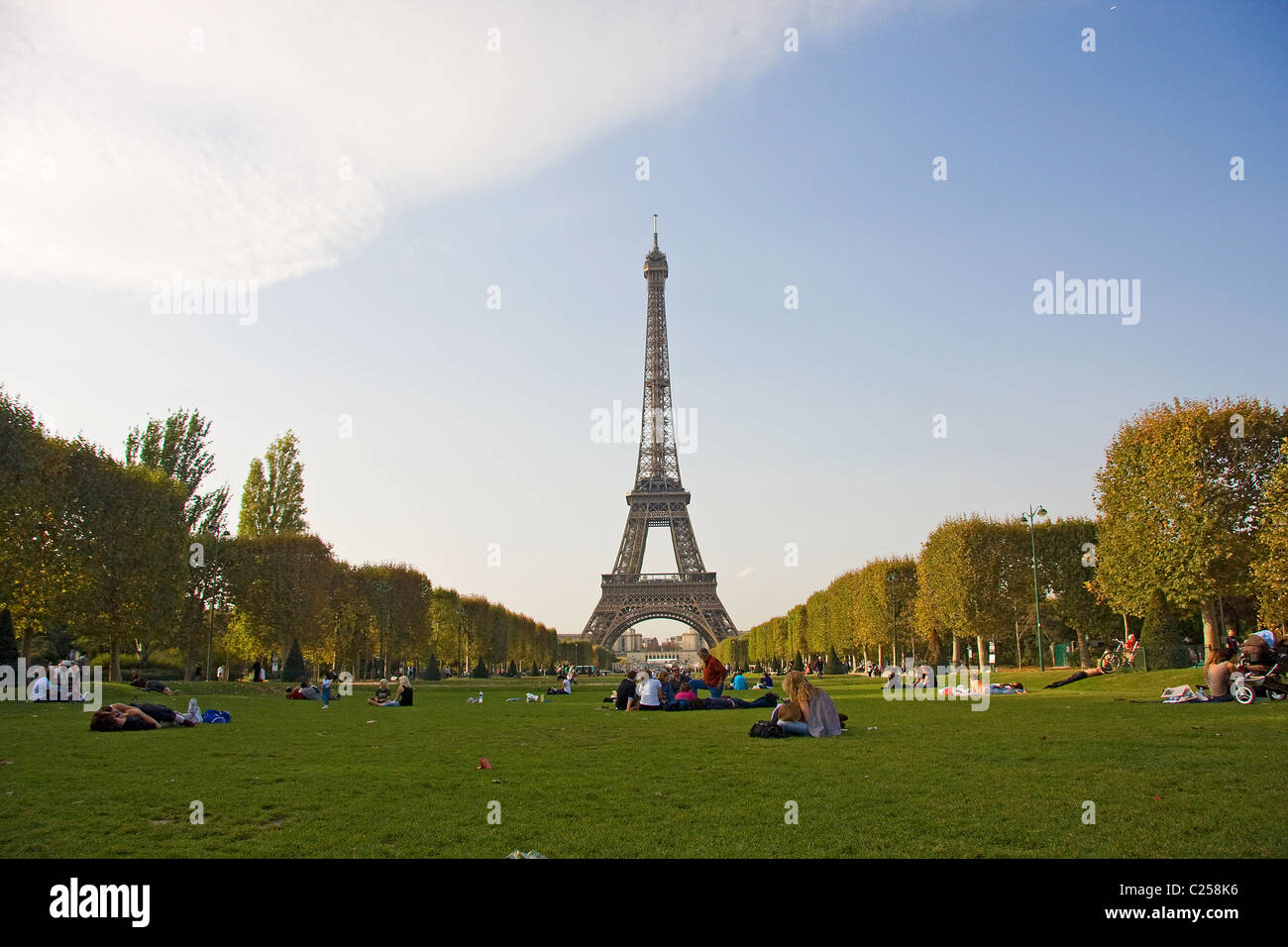 Parisians relax in the Parc du Champ de Mars, with the Eiffel Tower ...