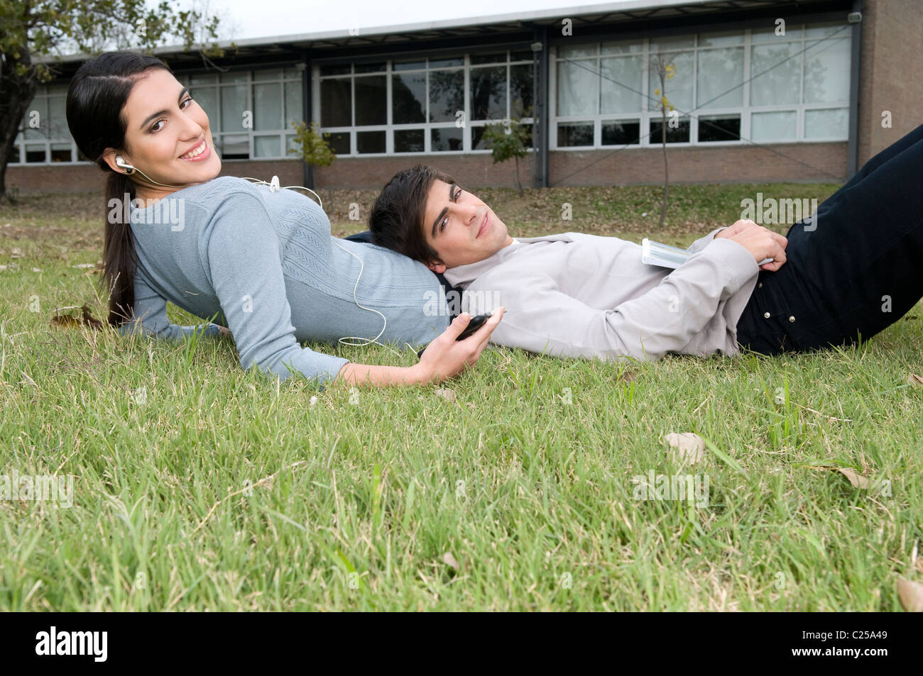 University students lying on the field Stock Photo - Alamy