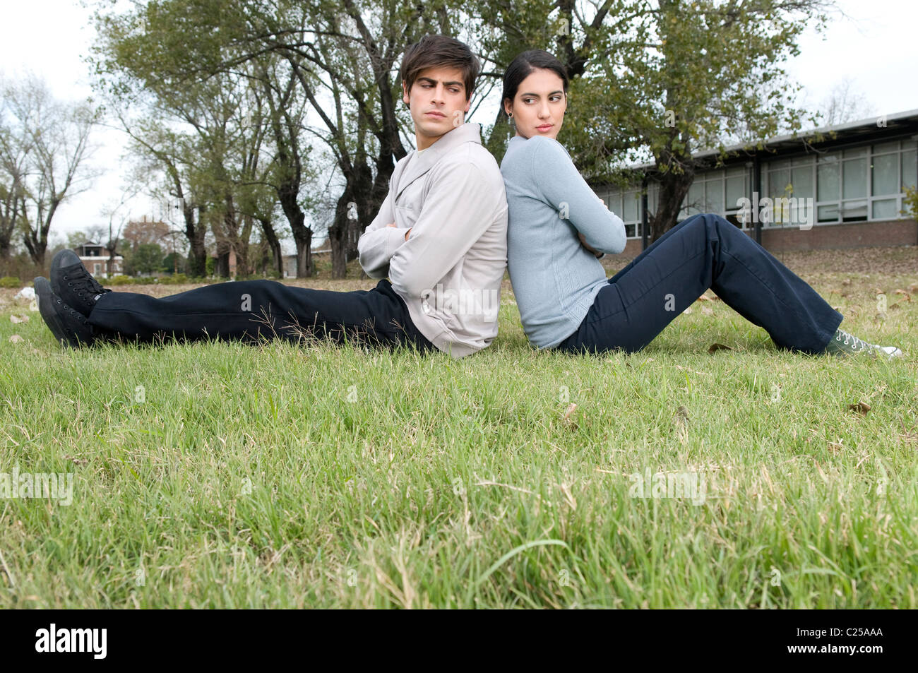 University students sitting on the field Stock Photo - Alamy