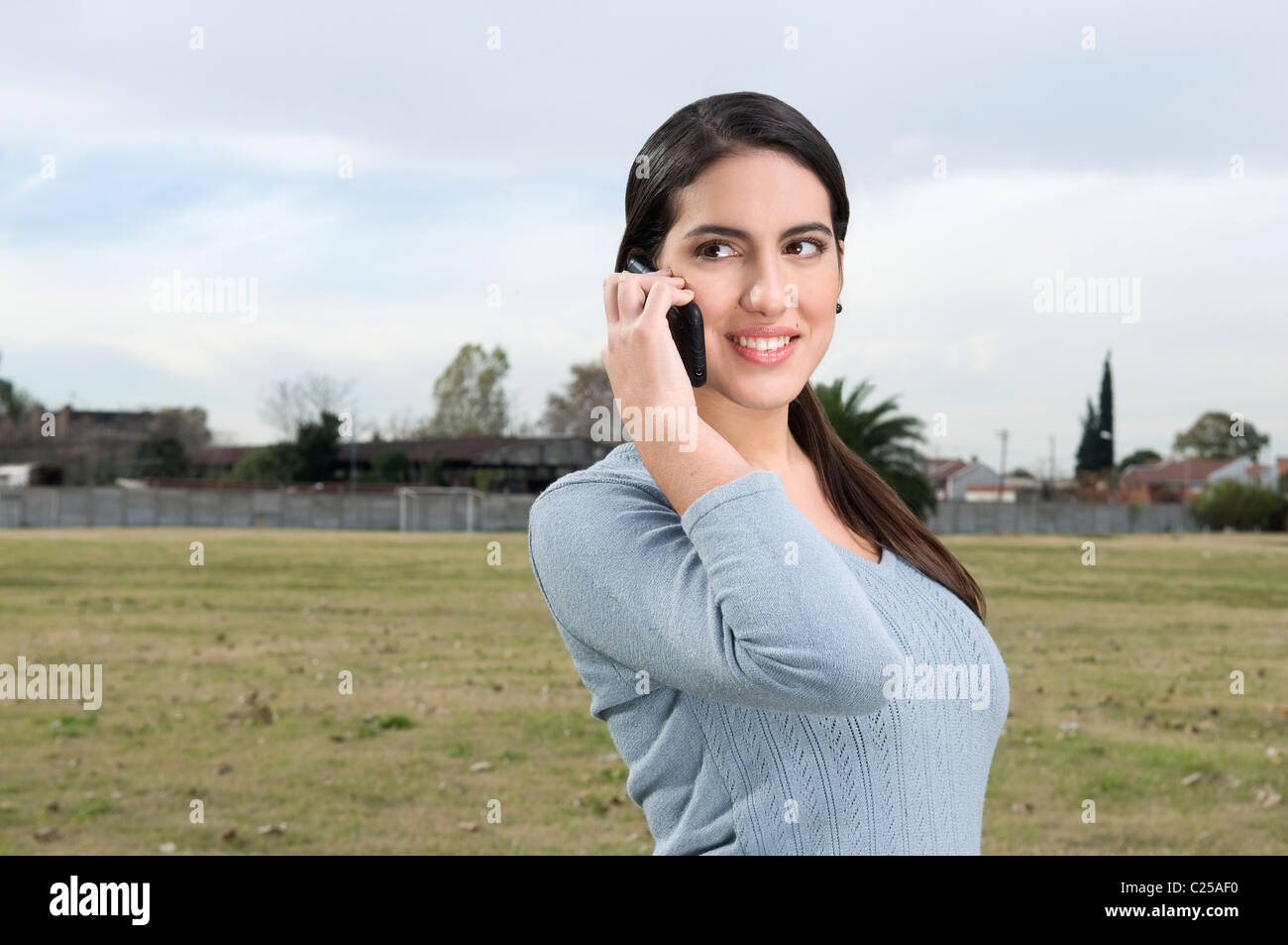Female university student taking by phone on campus Stock Photo - Alamy