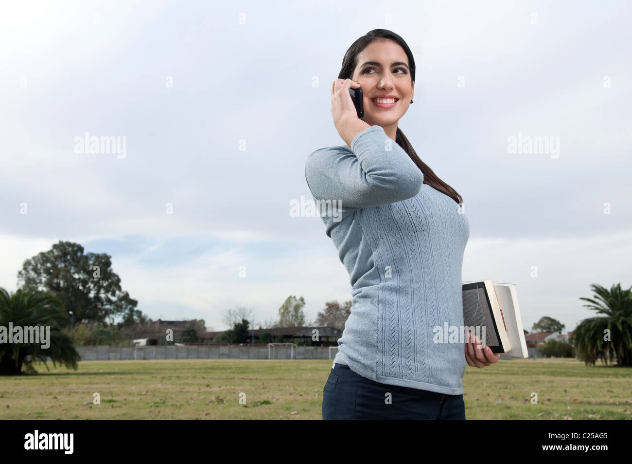 Female university student taking by phone on campus Stock Photo - Alamy