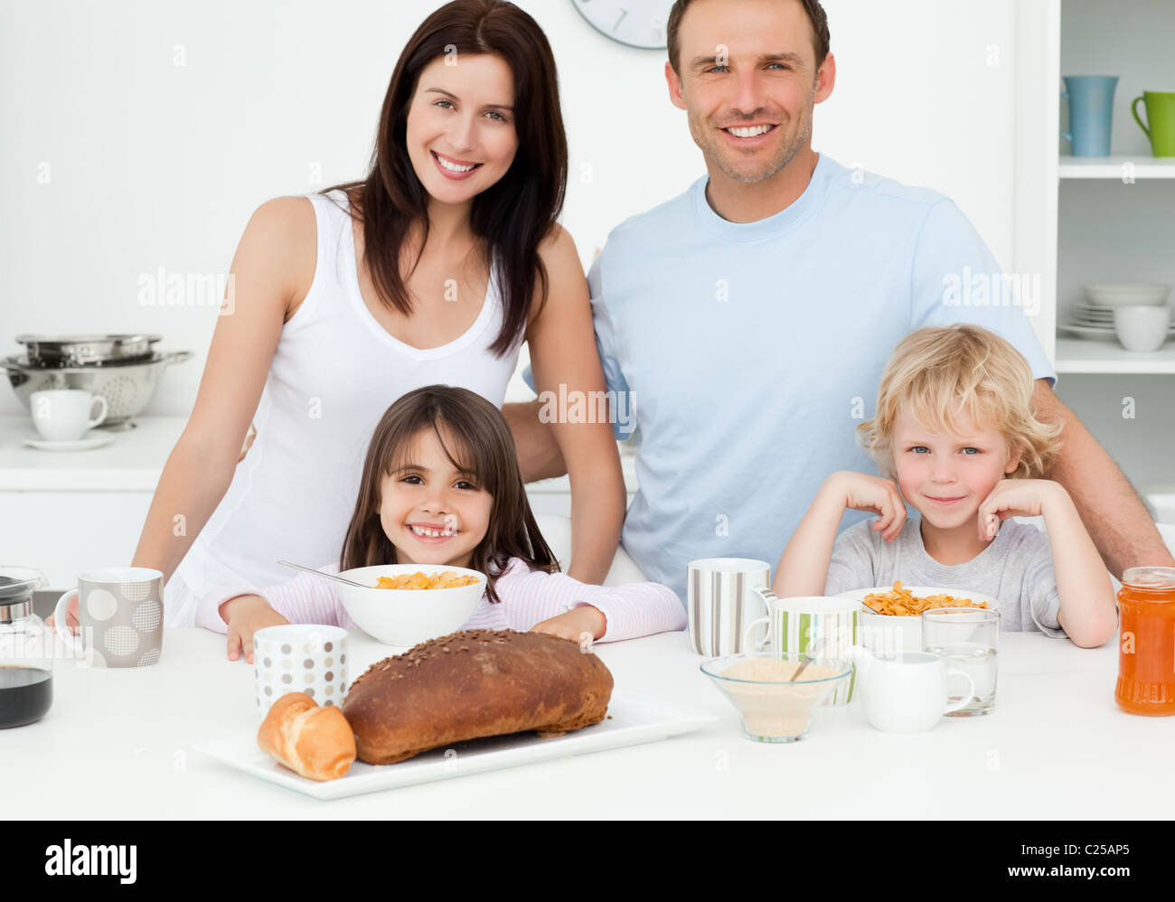 Cheerful family having breakfast together in the kitchen Stock Photo ...