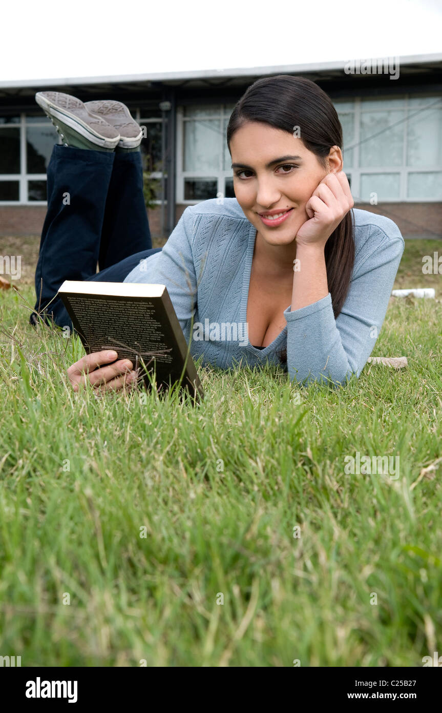 Female university student reading a book in campus Stock Photo - Alamy