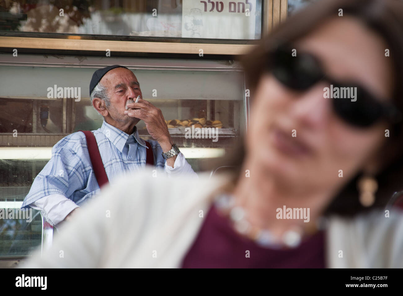 Elderly Jewish man smoking in background with out of focus shalow depth ...