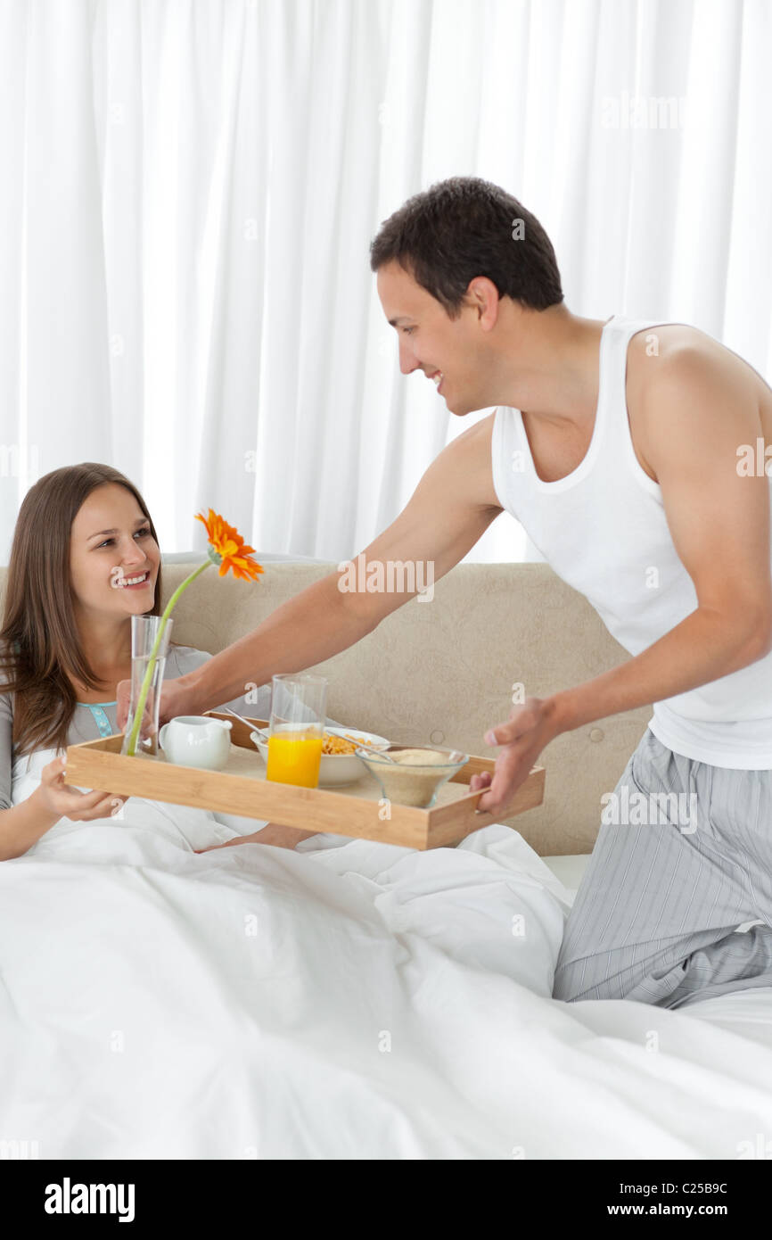 Attentive man bringing the breakfast to his girlfriend on the bed Stock ...