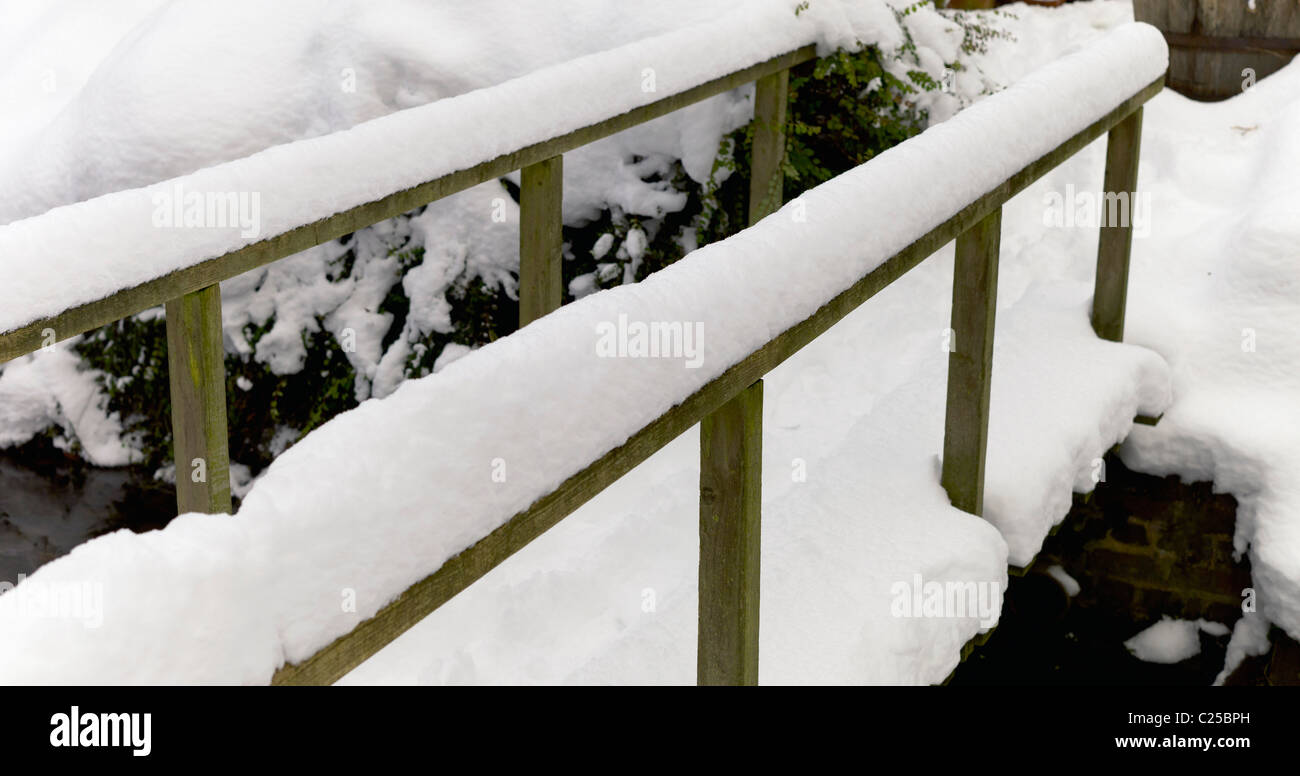 snow winter bridge footbridge stream garden Stock Photo - Alamy