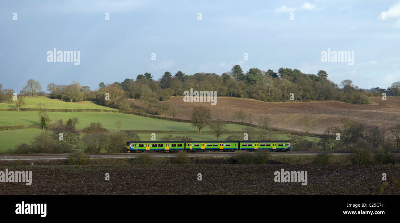 A train on a railway line in the countryside Stock Photo - Alamy