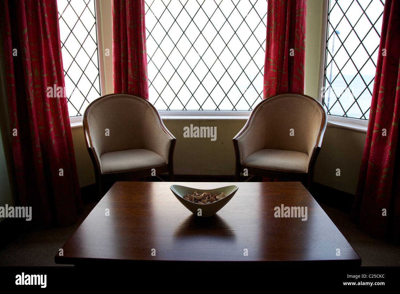 Two chairs in seaside hotel room facing away from the view Stock Photo ...