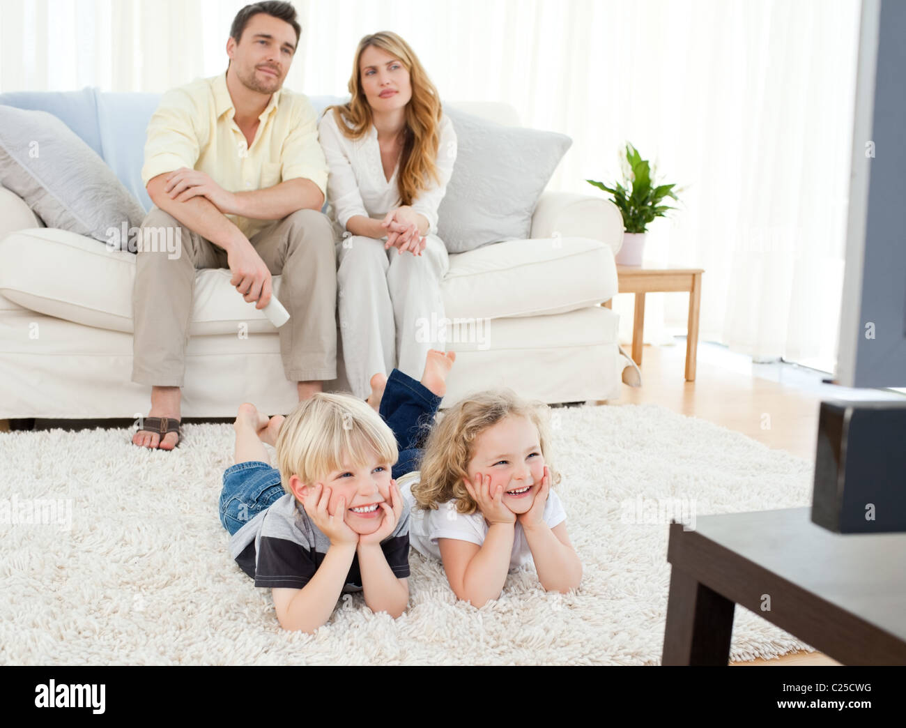 Adorable family watching tv Stock Photo - Alamy