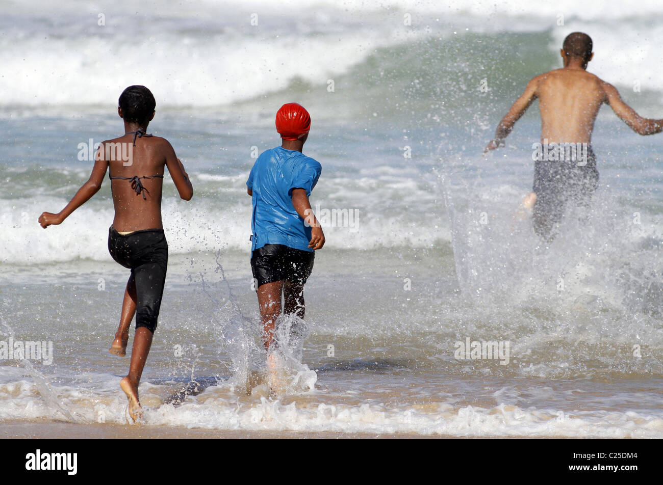 CHILDREN RUN INTO INDIAN OCEAN JEFFREY'S BAY EASTERN CAPE SOUTH AFRICA ...