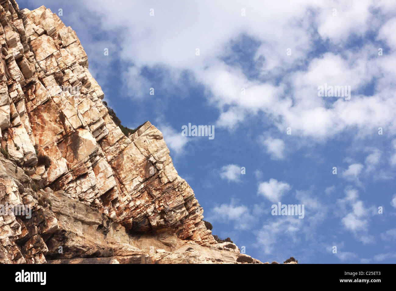A big rock under the blue clouded sky Stock Photo - Alamy