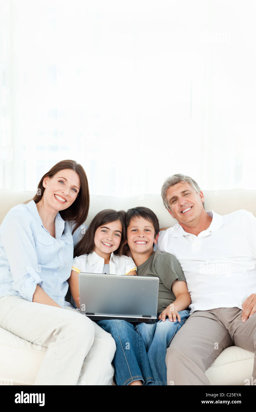Pretty family looking at the camera at home Stock Photo - Alamy