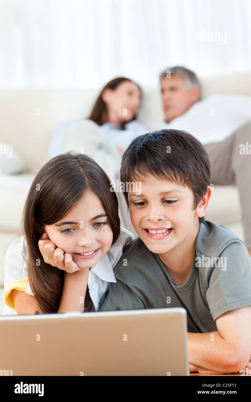 Lovely children watching a movie on their laptop at home Stock Photo ...
