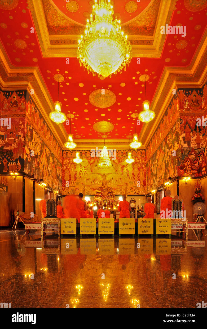 Buddhist monks praying during a service at the temple Stock Photo - Alamy