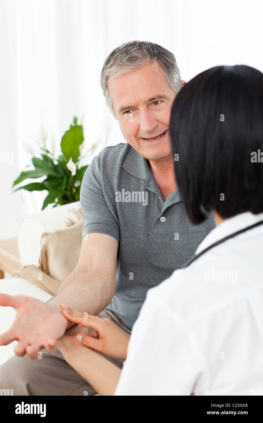 Nurse taking the pulse of her patient Stock Photo - Alamy