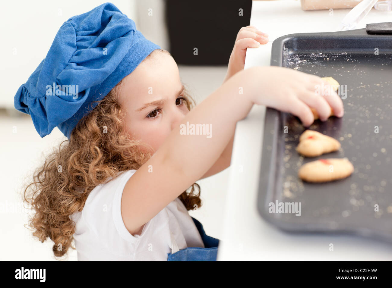 Little girl stealing cookies Stock Photo - Alamy