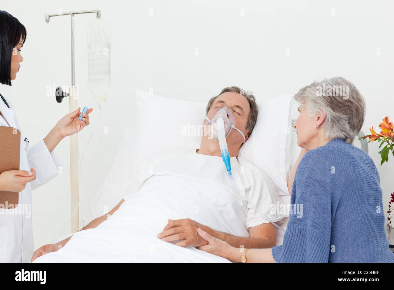 Nurse with a couple in a hospital Stock Photo - Alamy