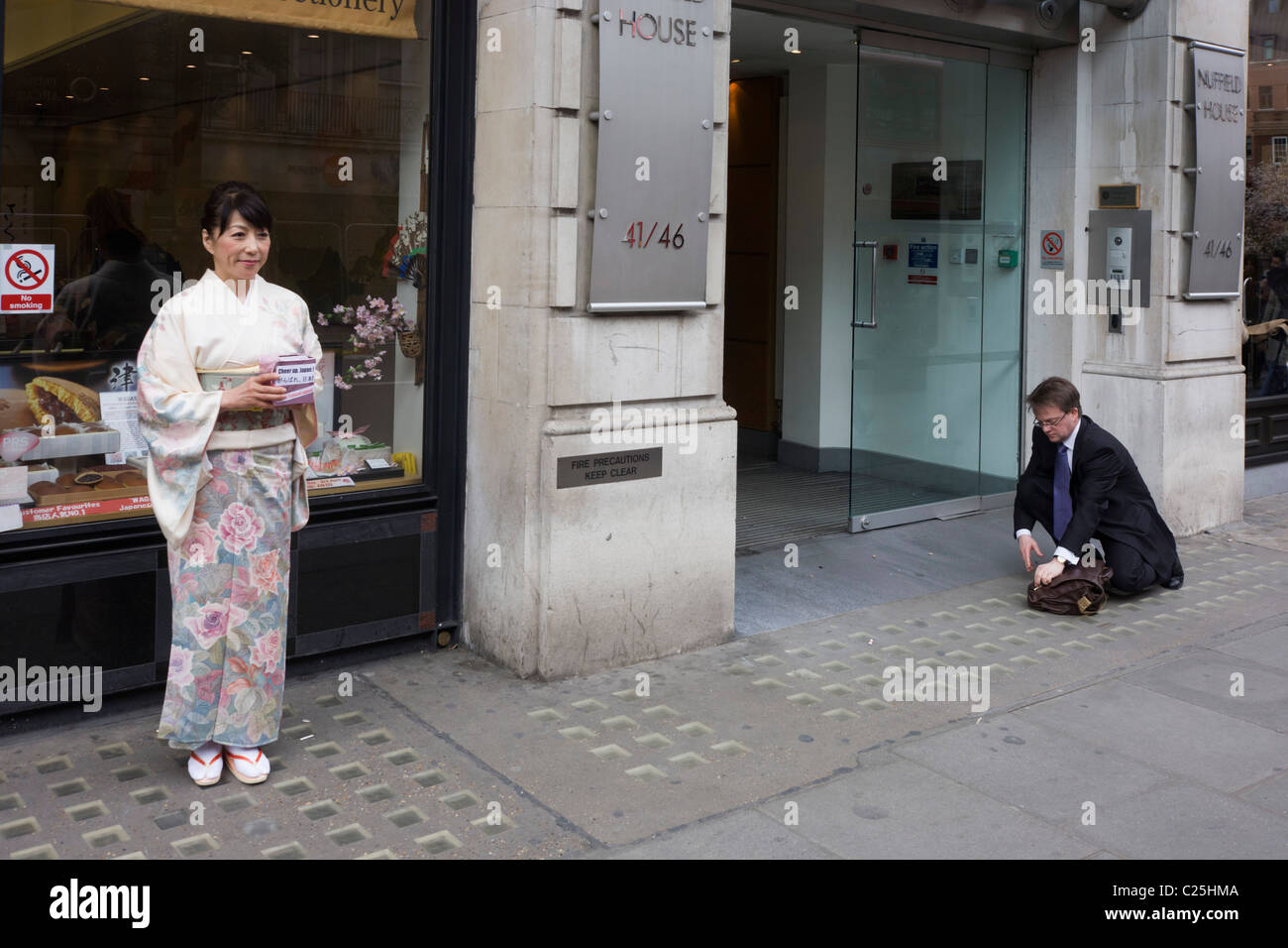 A geisha lady collects money from westerners in London for the Japanese ...