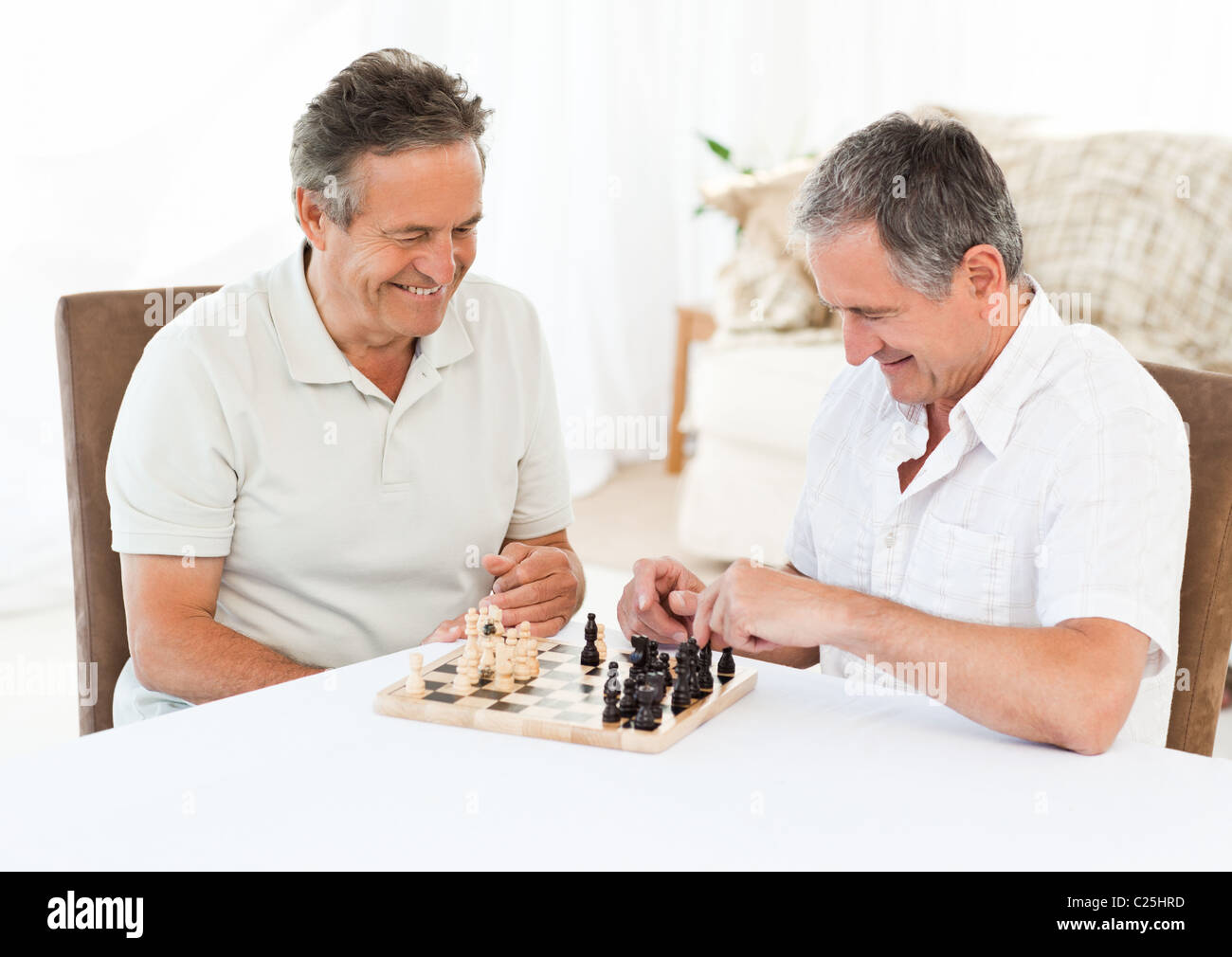 Seniors playing chess on the table Stock Photo - Alamy