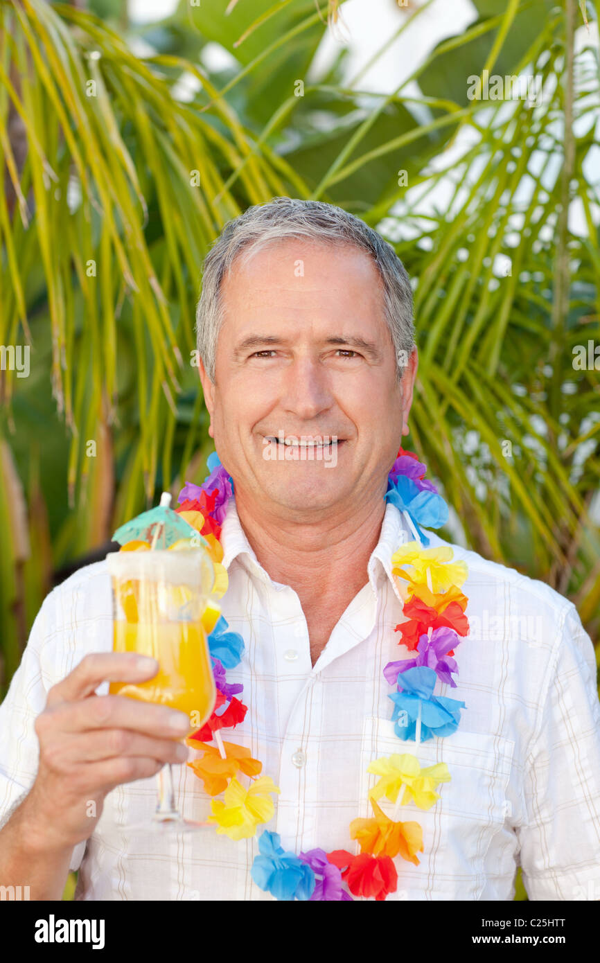 Mature man drinking a cocktail under the sun Stock Photo - Alamy