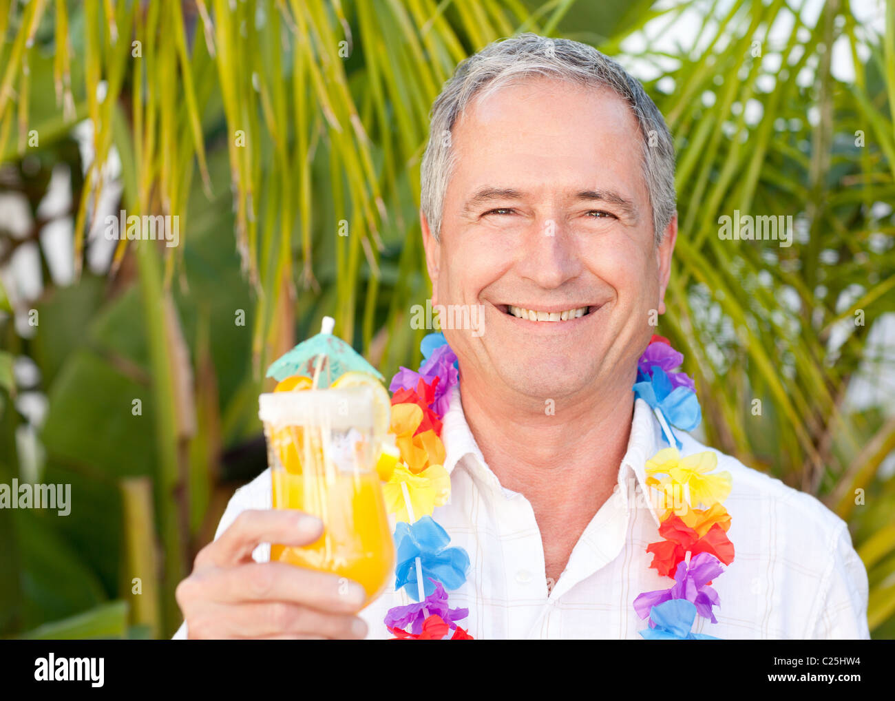 Mature man drinking a cocktail under the sun Stock Photo - Alamy