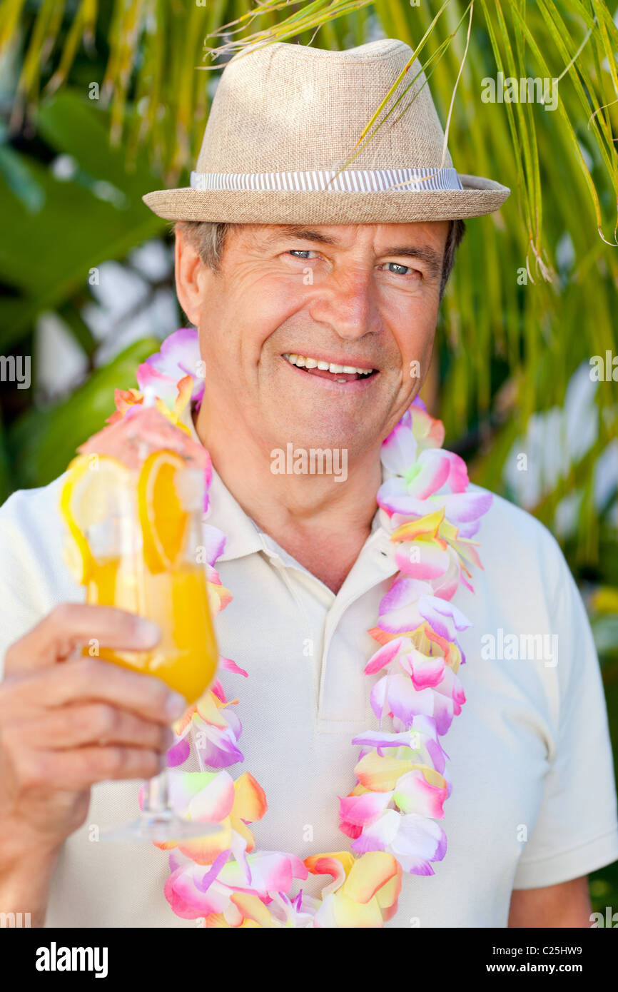 Mature man drinking a cocktail under the sun Stock Photo - Alamy