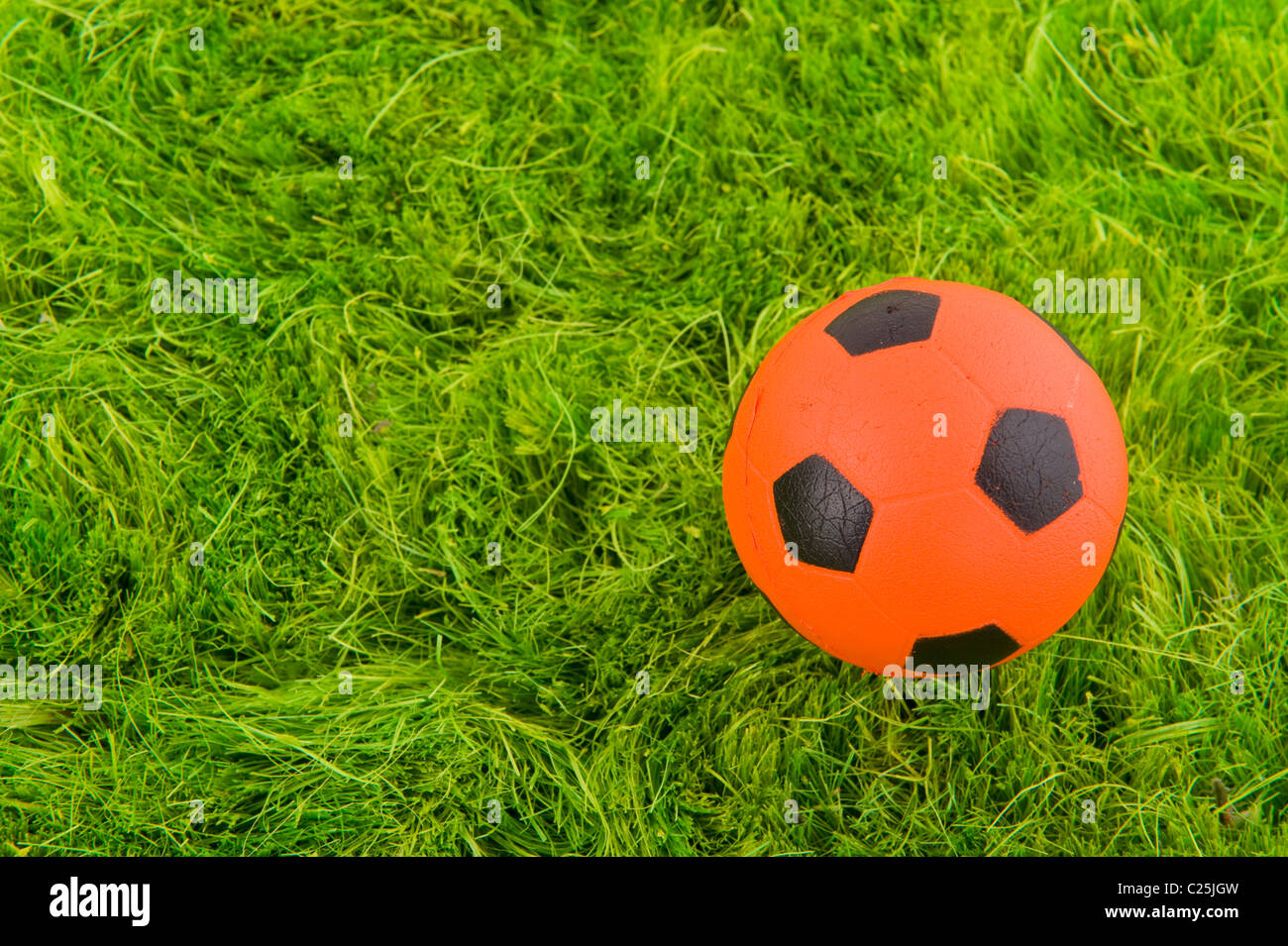 Dutch soccer orange ball in green grass Stock Photo - Alamy