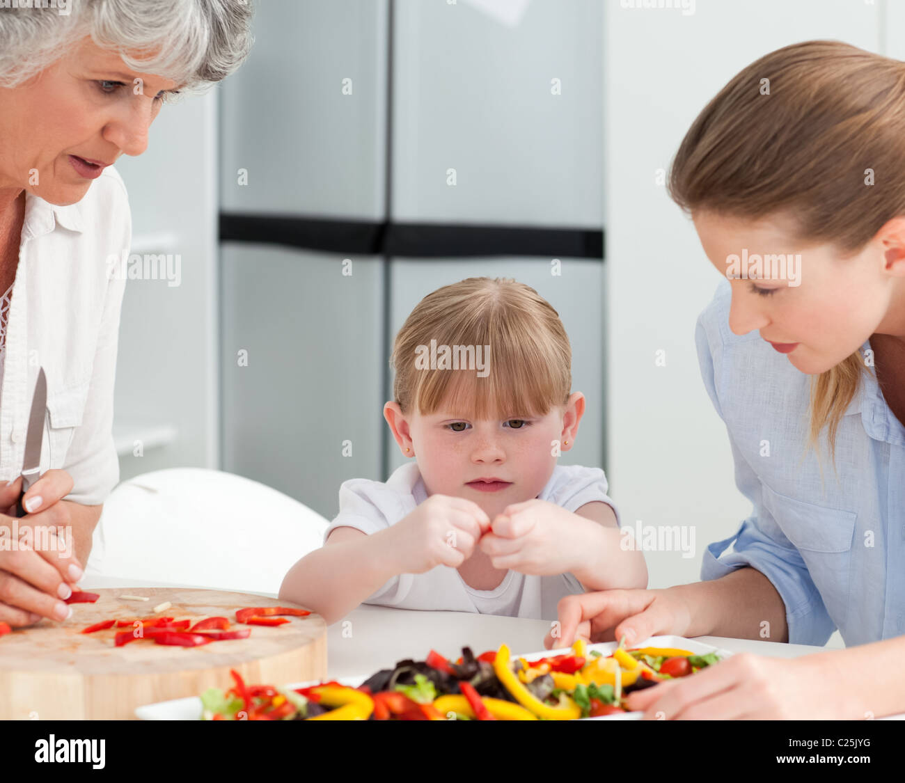 Family cooking together in the kitchen at home Stock Photo - Alamy