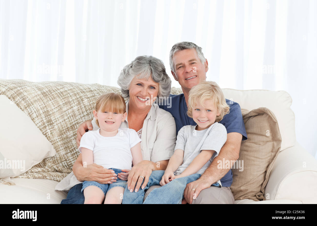 Joyful family looking at the camera Stock Photo - Alamy