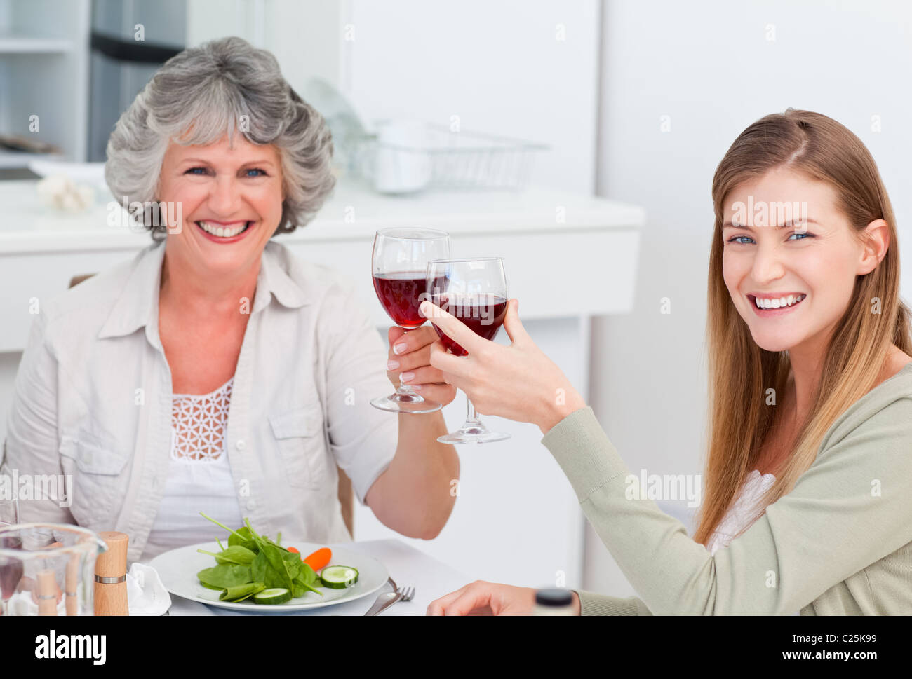 Woman drinking with her mother Stock Photo - Alamy