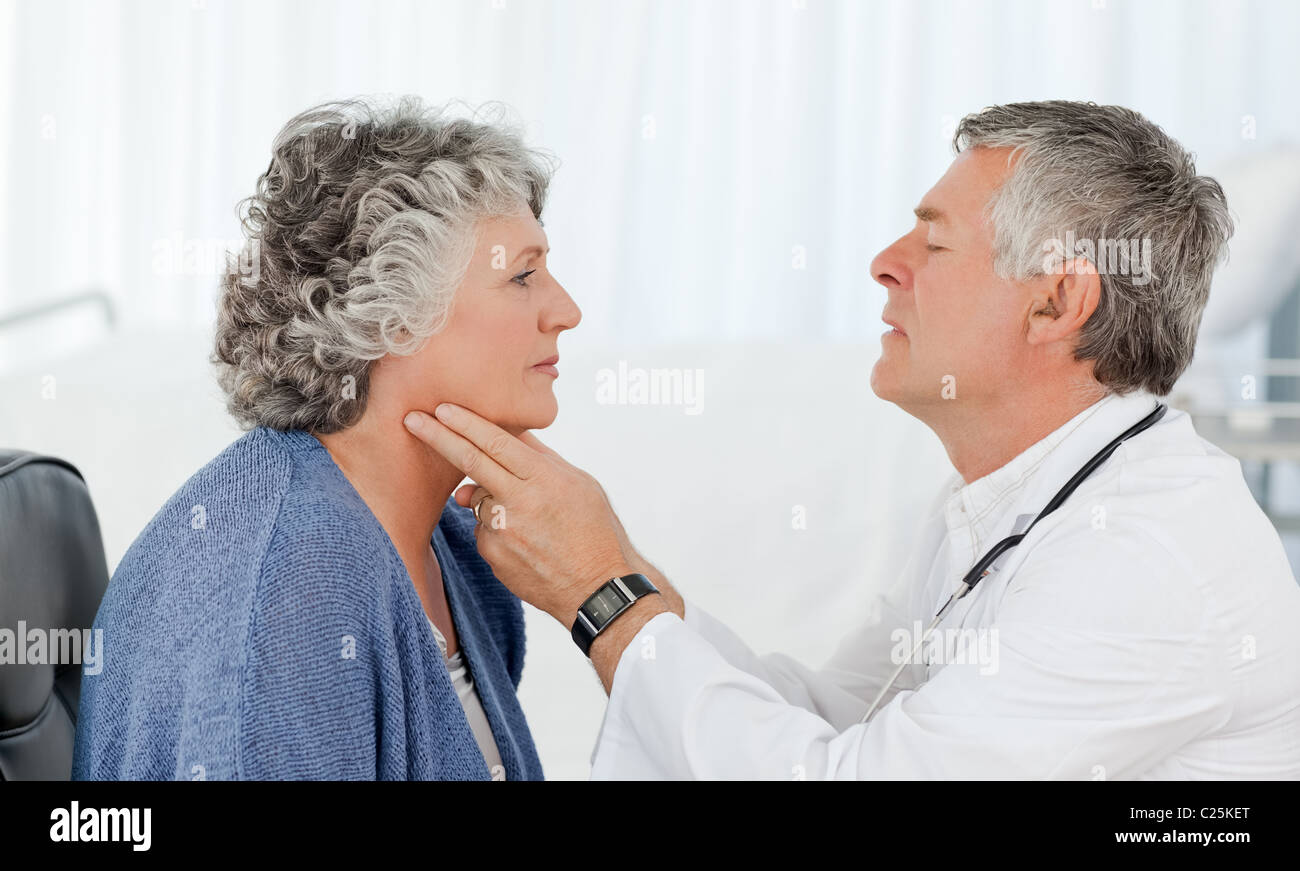 A senior doctor doing an examination of his patient Stock Photo - Alamy
