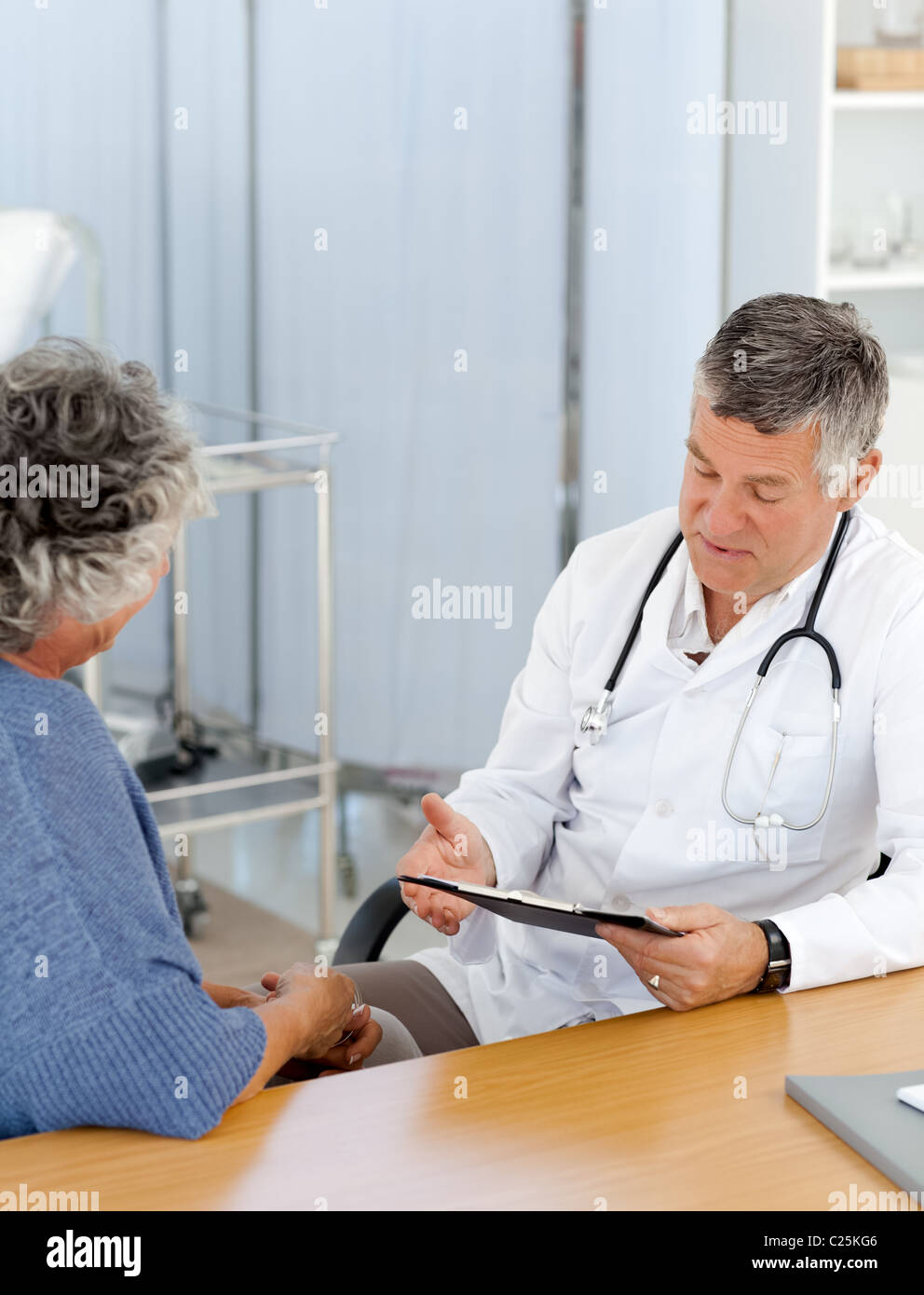 A senior doctor with his patient in his office Stock Photo - Alamy