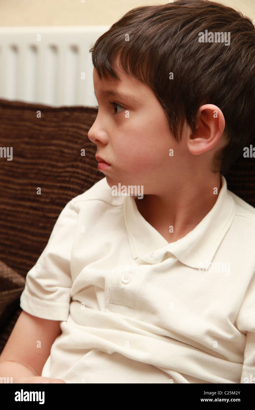 Side profile of 5 year old boy looking sad Stock Photo - Alamy