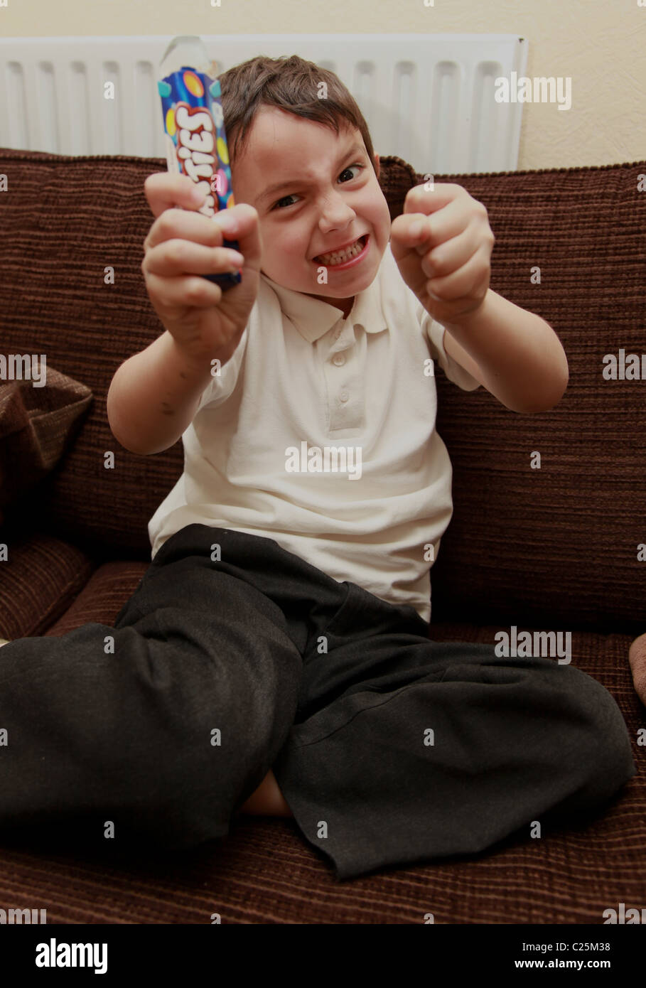 5 year old boy eating Smarties Stock Photo - Alamy