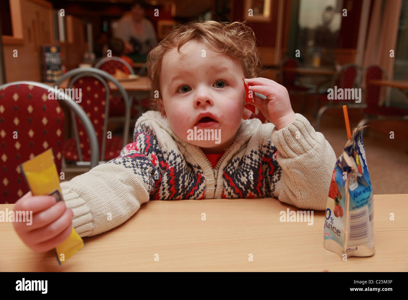 Bored toddler waiting for his meal in a restaurant Stock Photo - Alamy