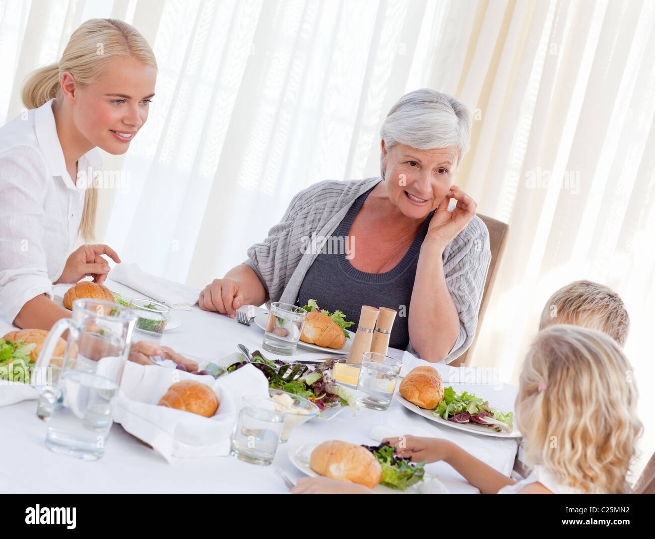 Family talking together at table Stock Photo - Alamy
