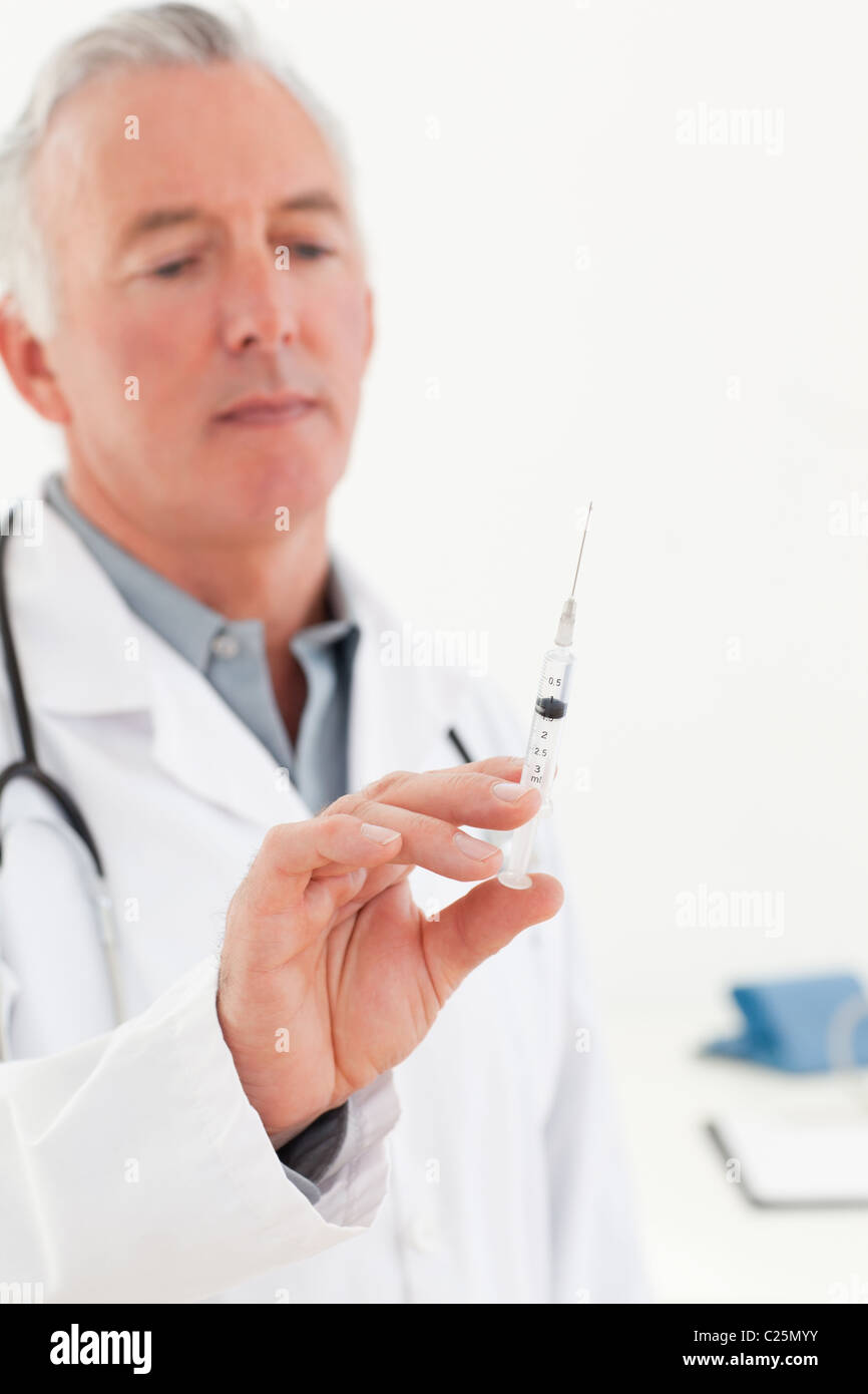 Senior doctor with syringes Stock Photo - Alamy