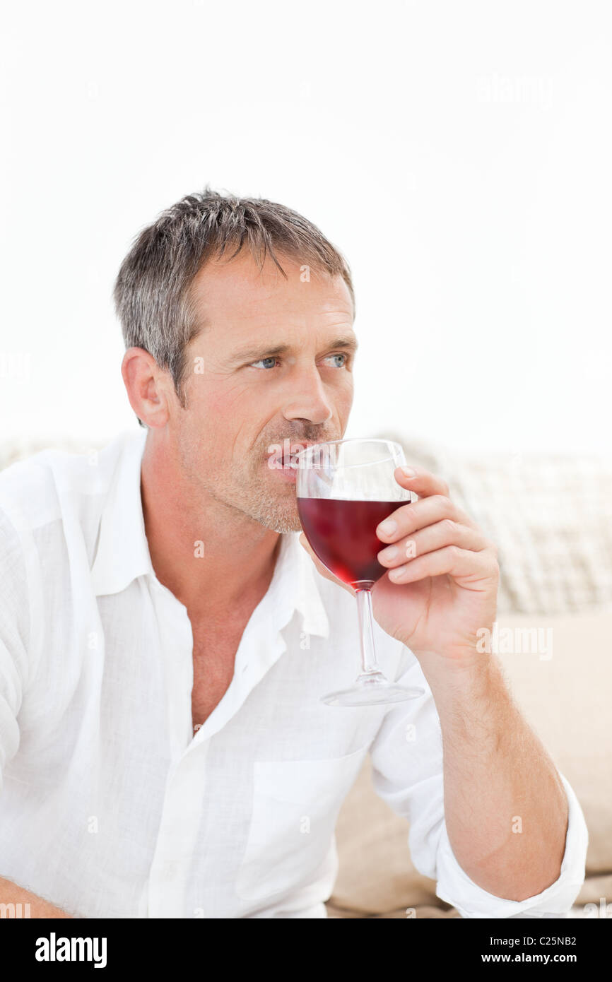 Handsome man drinking some red wine Stock Photo - Alamy