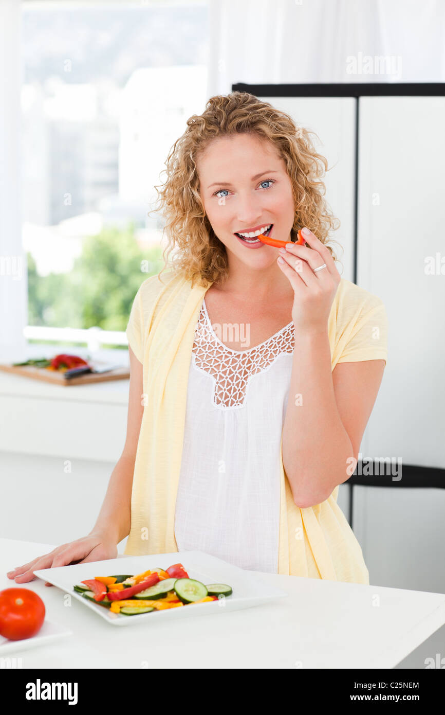Beautiful woman is eating vegetables Stock Photo - Alamy