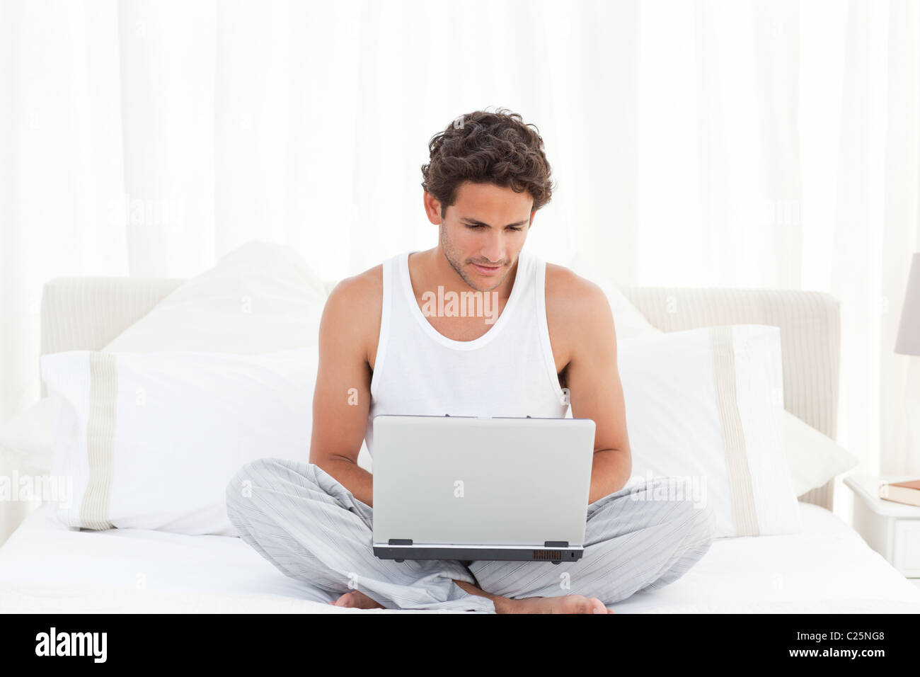 Man working on his laptop at home Stock Photo - Alamy