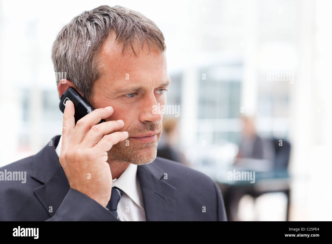 Businessman phoning in his office Stock Photo - Alamy