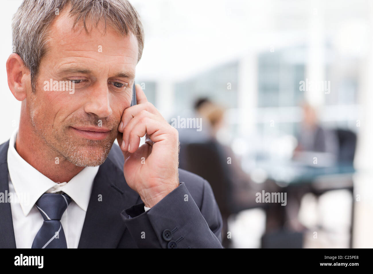 Businessman phoning in his office Stock Photo - Alamy