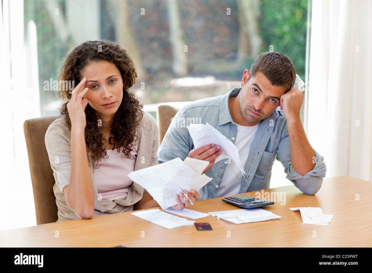 Young couple calculating their domestic bills Stock Photo - Alamy