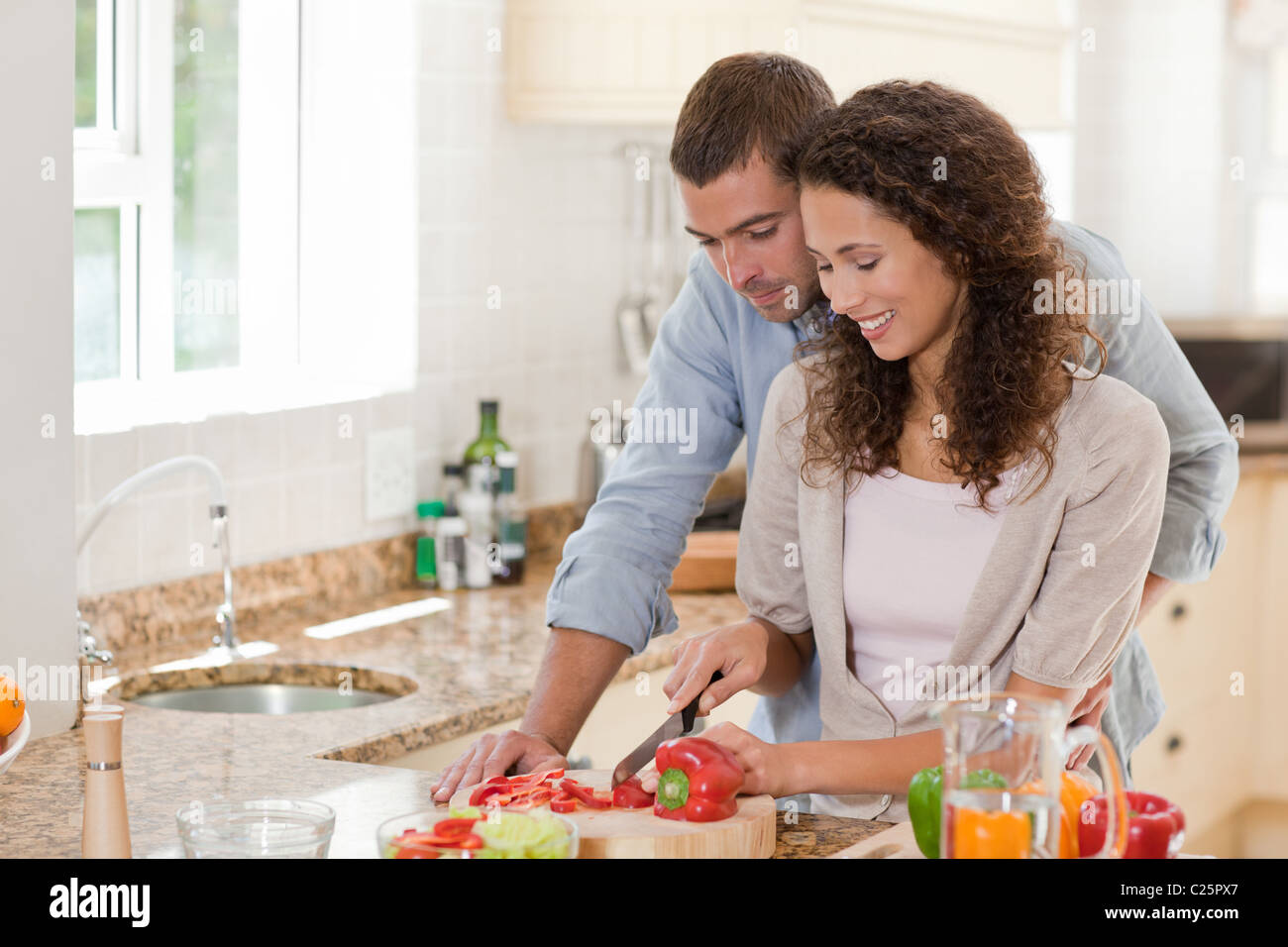 Handsome man cooking with his girlfriend Stock Photo - Alamy