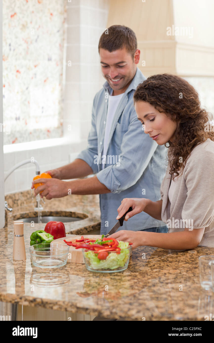 Handsome man cooking with his girlfriend Stock Photo - Alamy