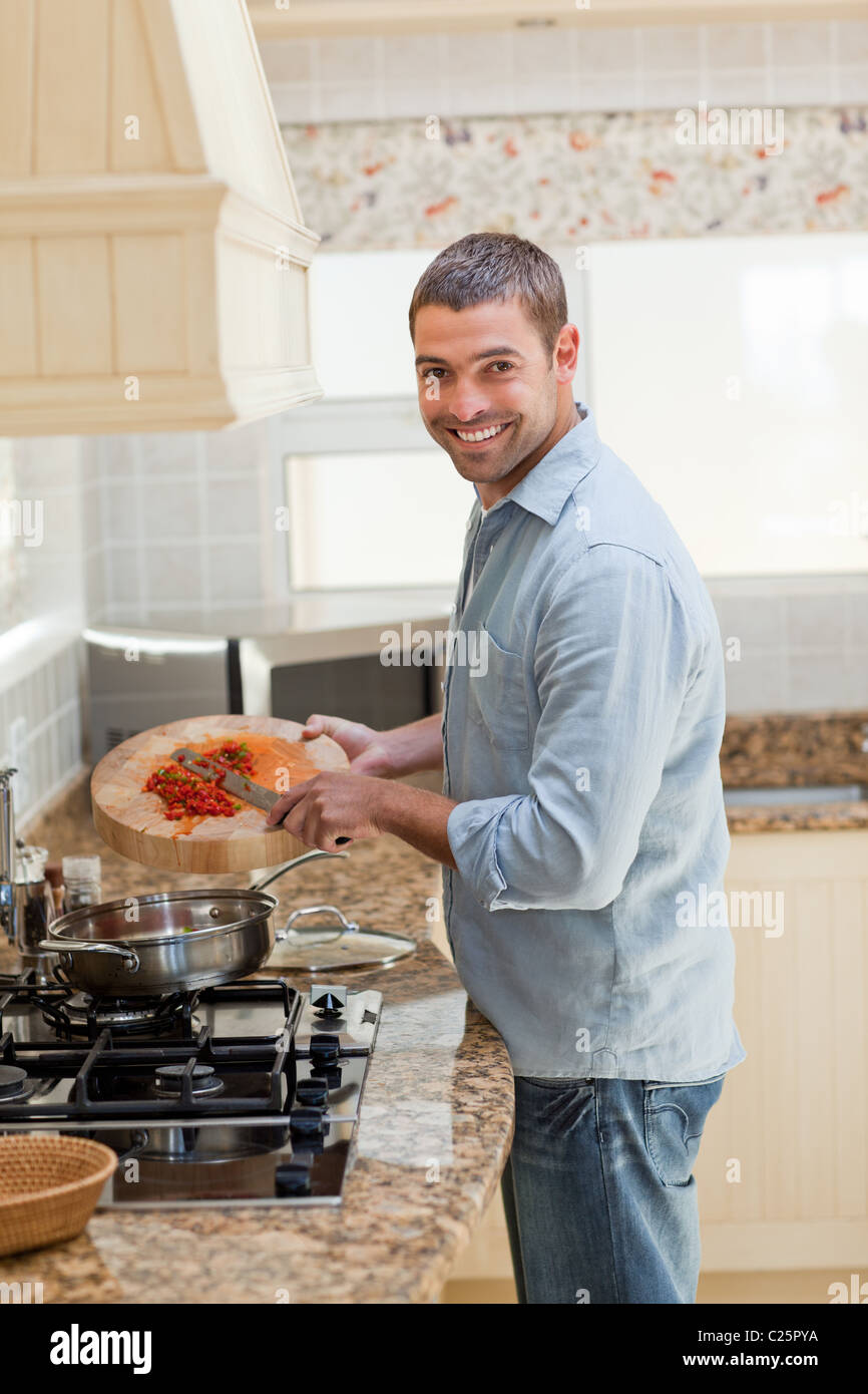 Handsome man cooking in the kitchen Stock Photo - Alamy