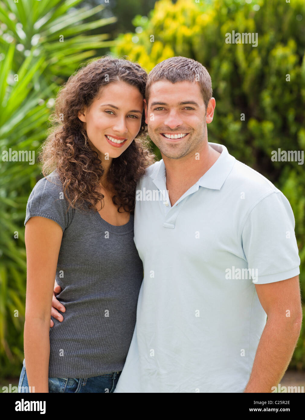 Happy couple hugging in the garden Stock Photo - Alamy