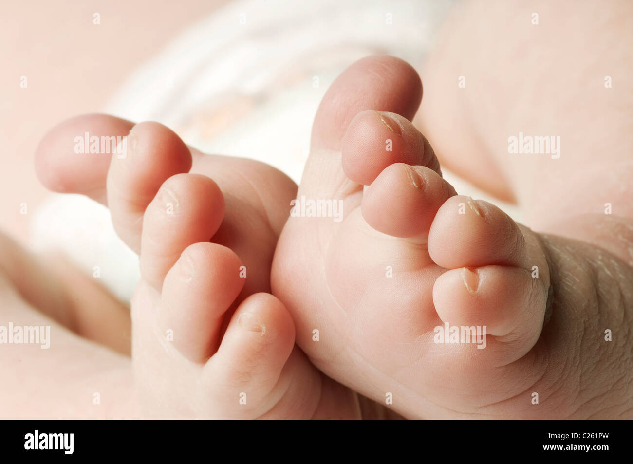 close-up of tiny baby's sole of fee and toes with the rest of baby's ...