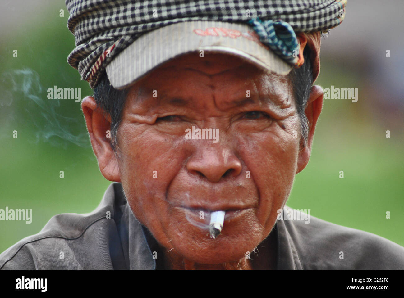 Cambodian man smoking cigarette hi-res stock photography and images - Alamy